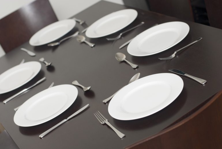 Black dining table set with clean white plates - Free Stock Image