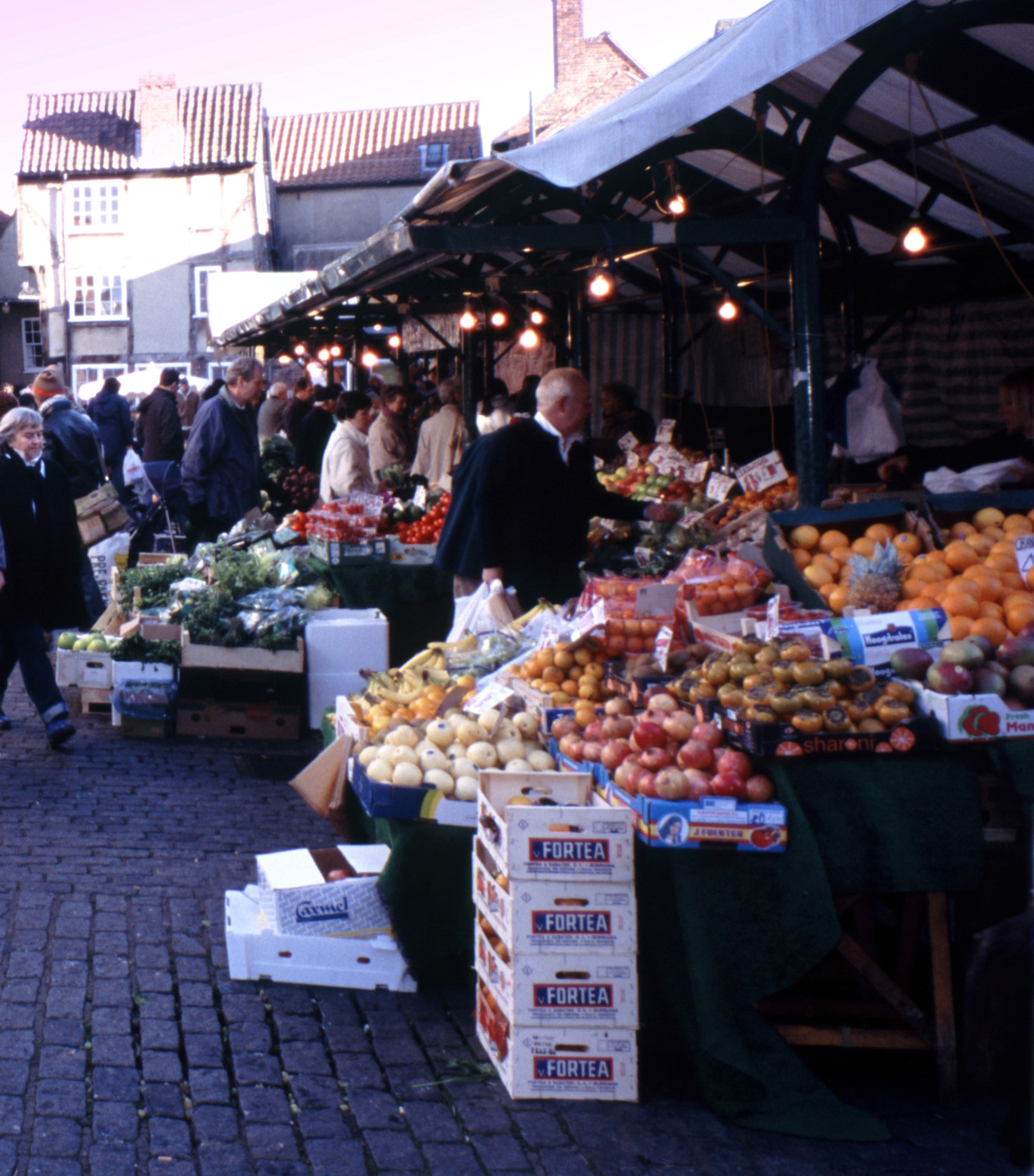Shoppers at an outdoor produce market - Free Stock Image